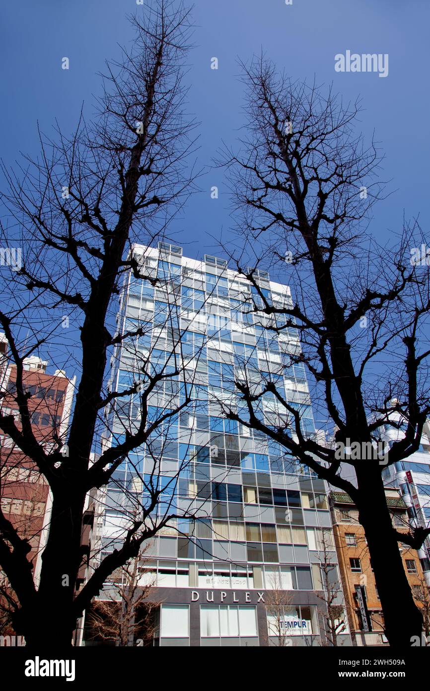 Modern blue glass building in Gina, Tokyo, Japan Stock Photo - Alamy