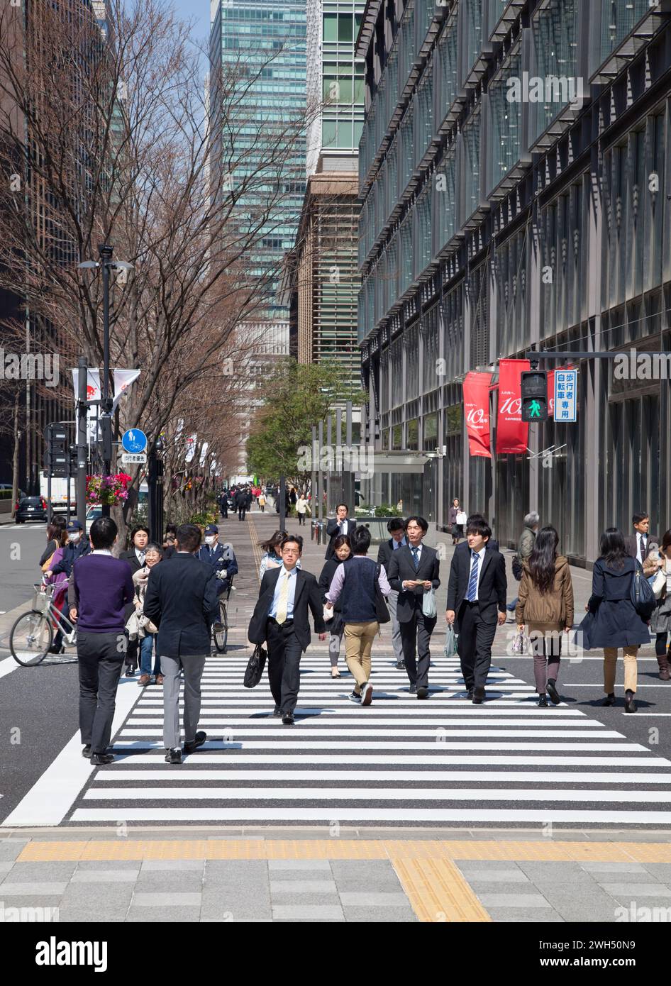 Typical scene in Tokyo with tall buildings and people walking on the ...