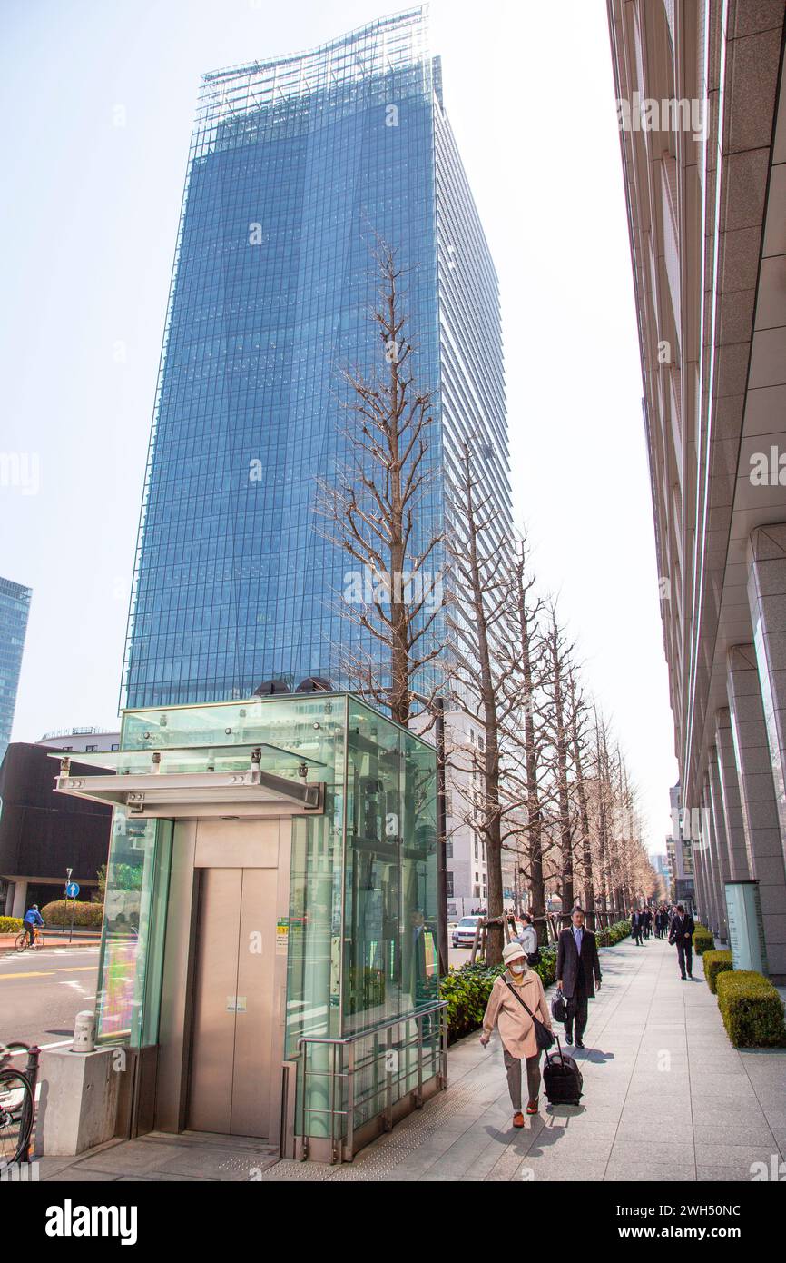 Typical scene in Tokyo with tall buildings and people walking on the ...