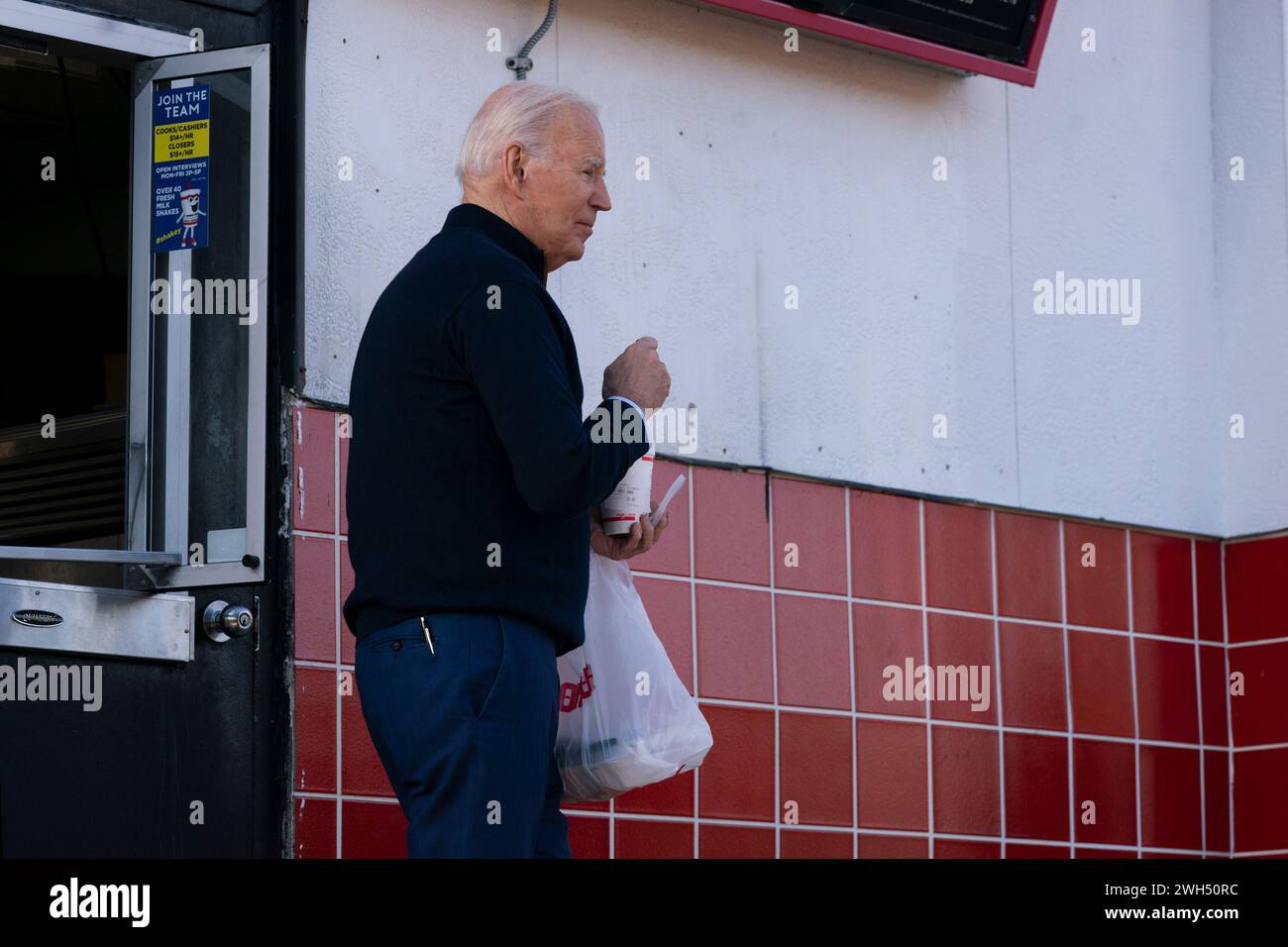President Joe Biden walks with his food order from the take out window ...