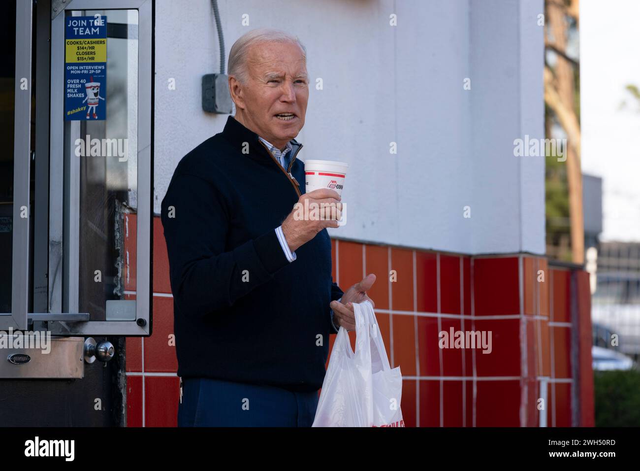 President Joe Biden walks with his food order from the take out window ...