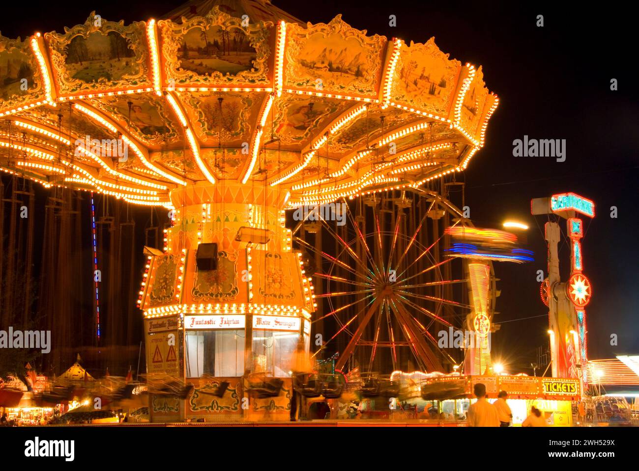 Wave Swinger carnival ride with ferris wheel, Oregon State Fair, Salem ...