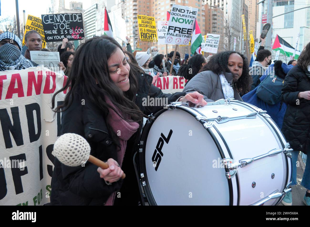 Pro-Palestine demonstrators play the drum as other demonstrators hold ...