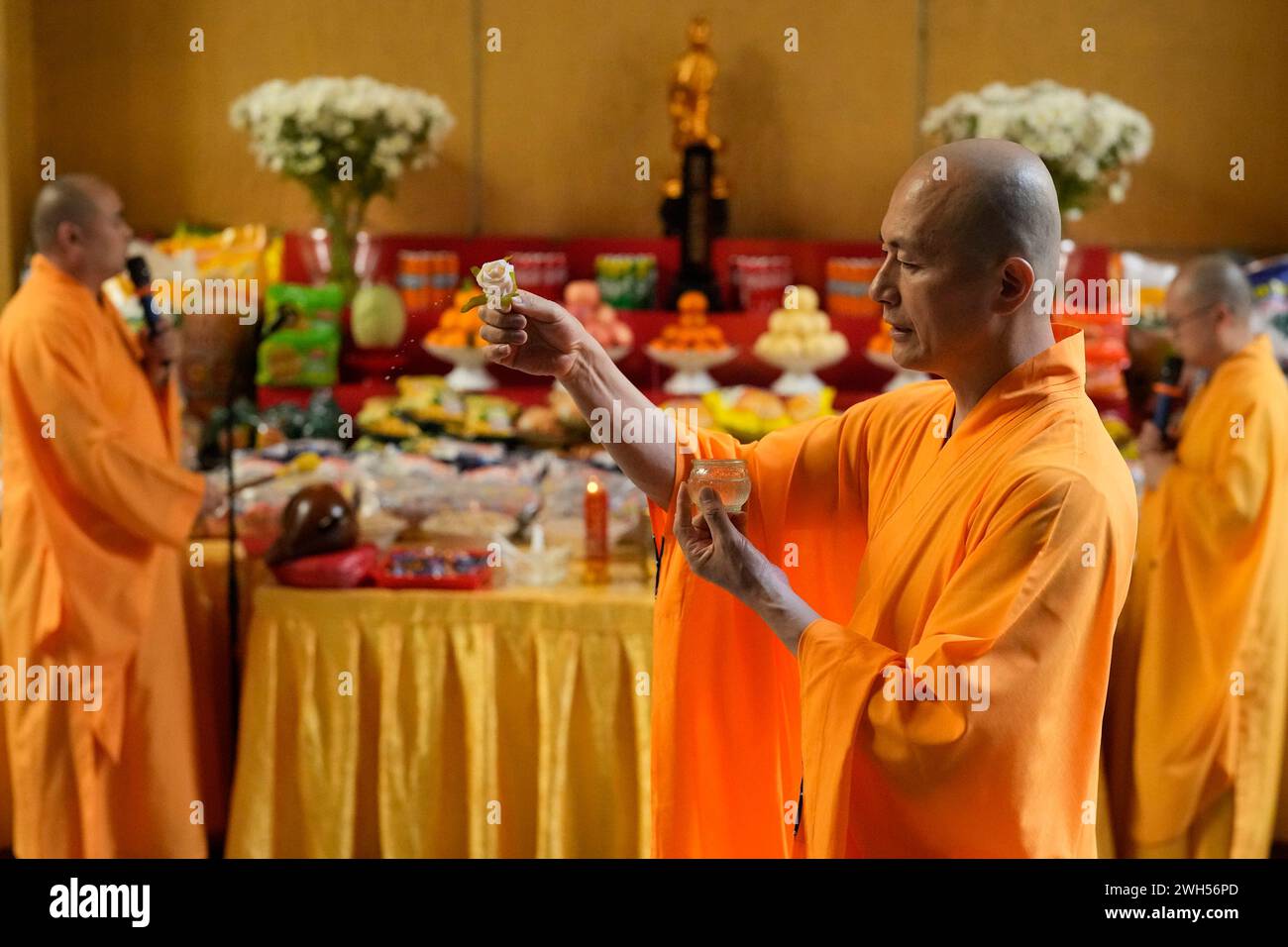 A monk holds a rose during ceremonies as part of their observance of ...