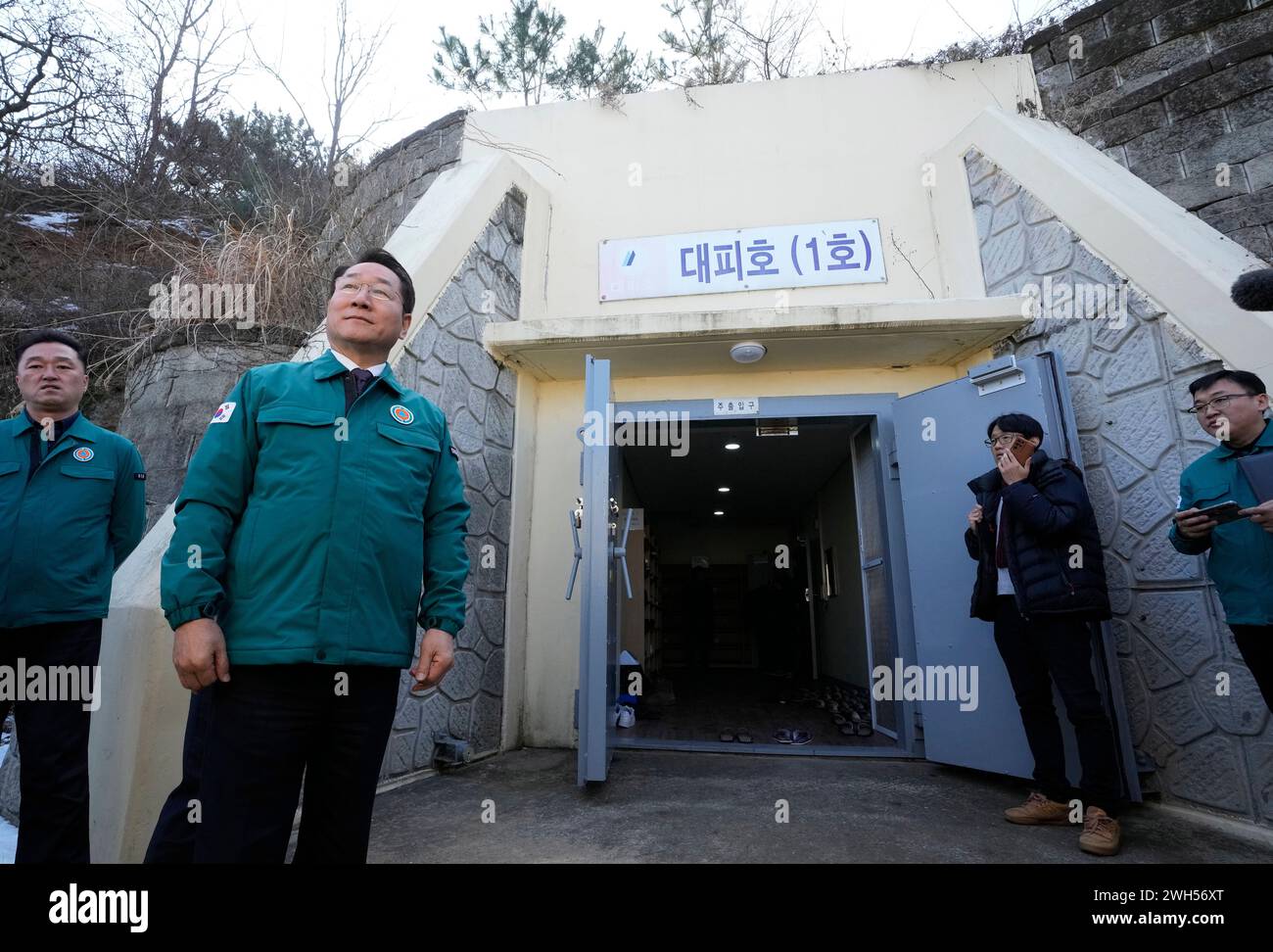 Incheon Mayor Yoo Jeong-bok, second from left, stands in front of a ...