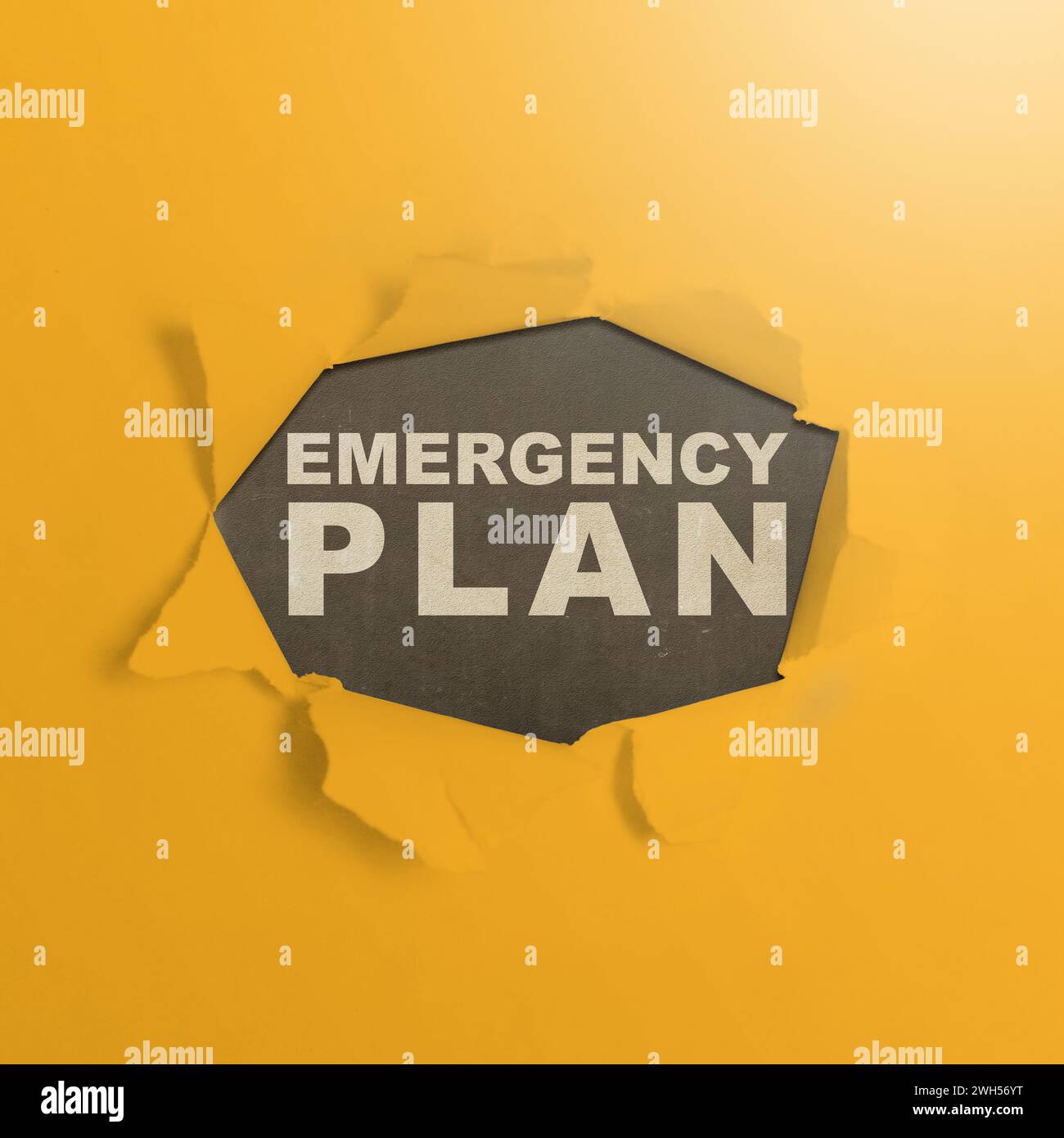 Ripped paper with 'Emergency plan' text with a black background ...