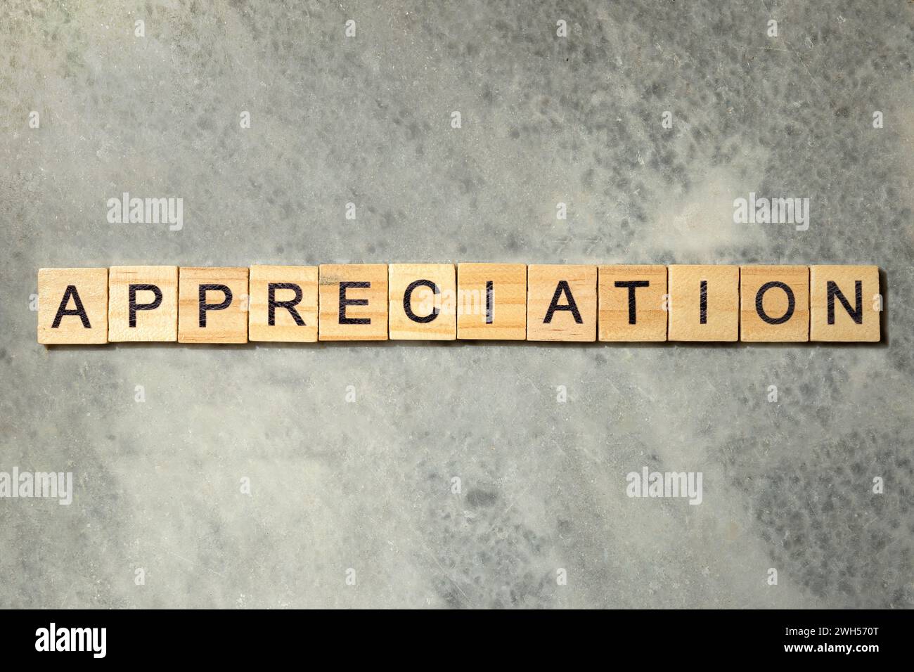 The row of wooden cubes with 'Appreciation' text on a black background ...