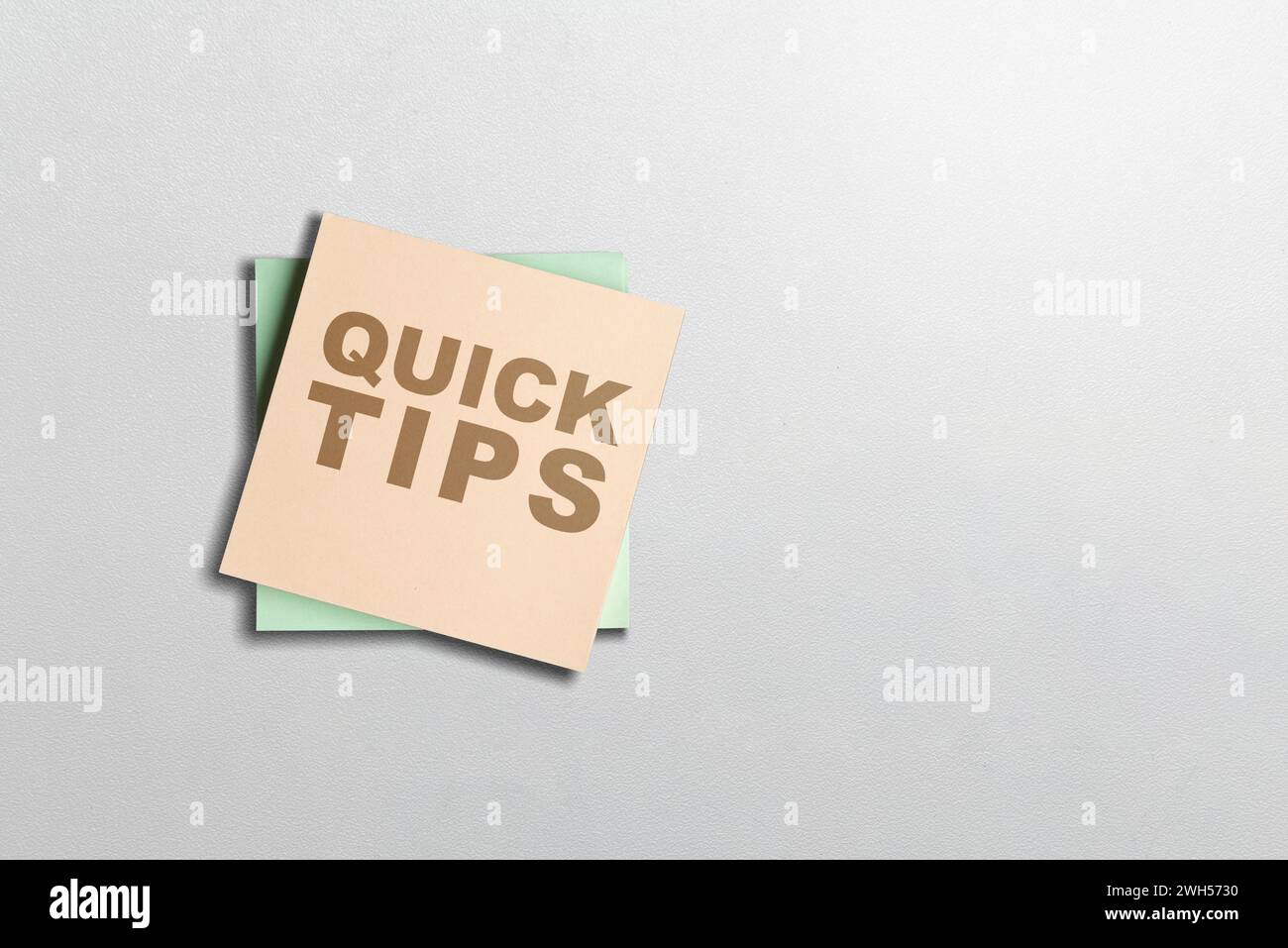 Stack of note paper with 'Quick tips' text on a white background. Tips ...