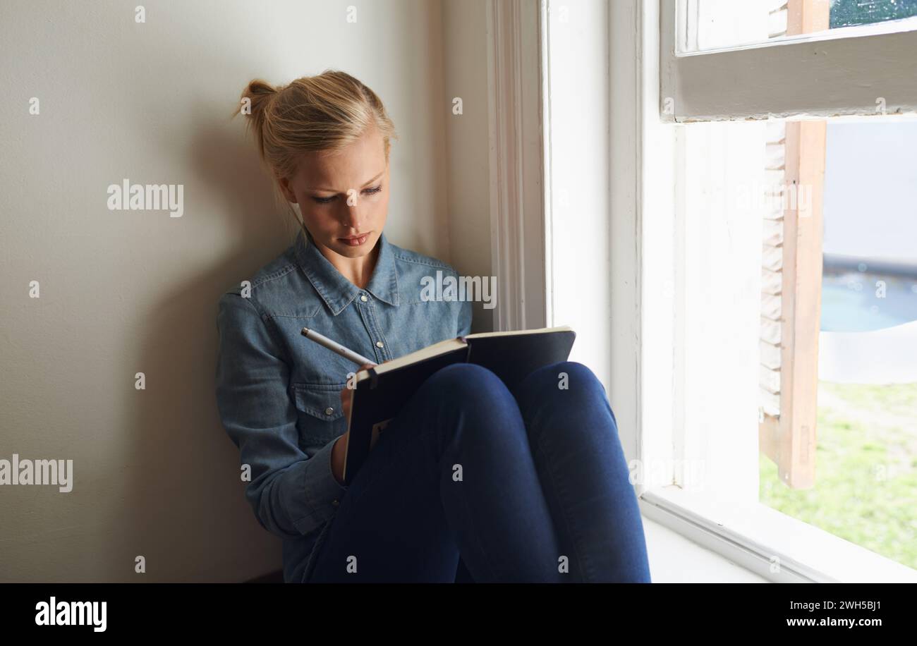 Woman, window and writing ideas in notebook, planning and brainstorming ...