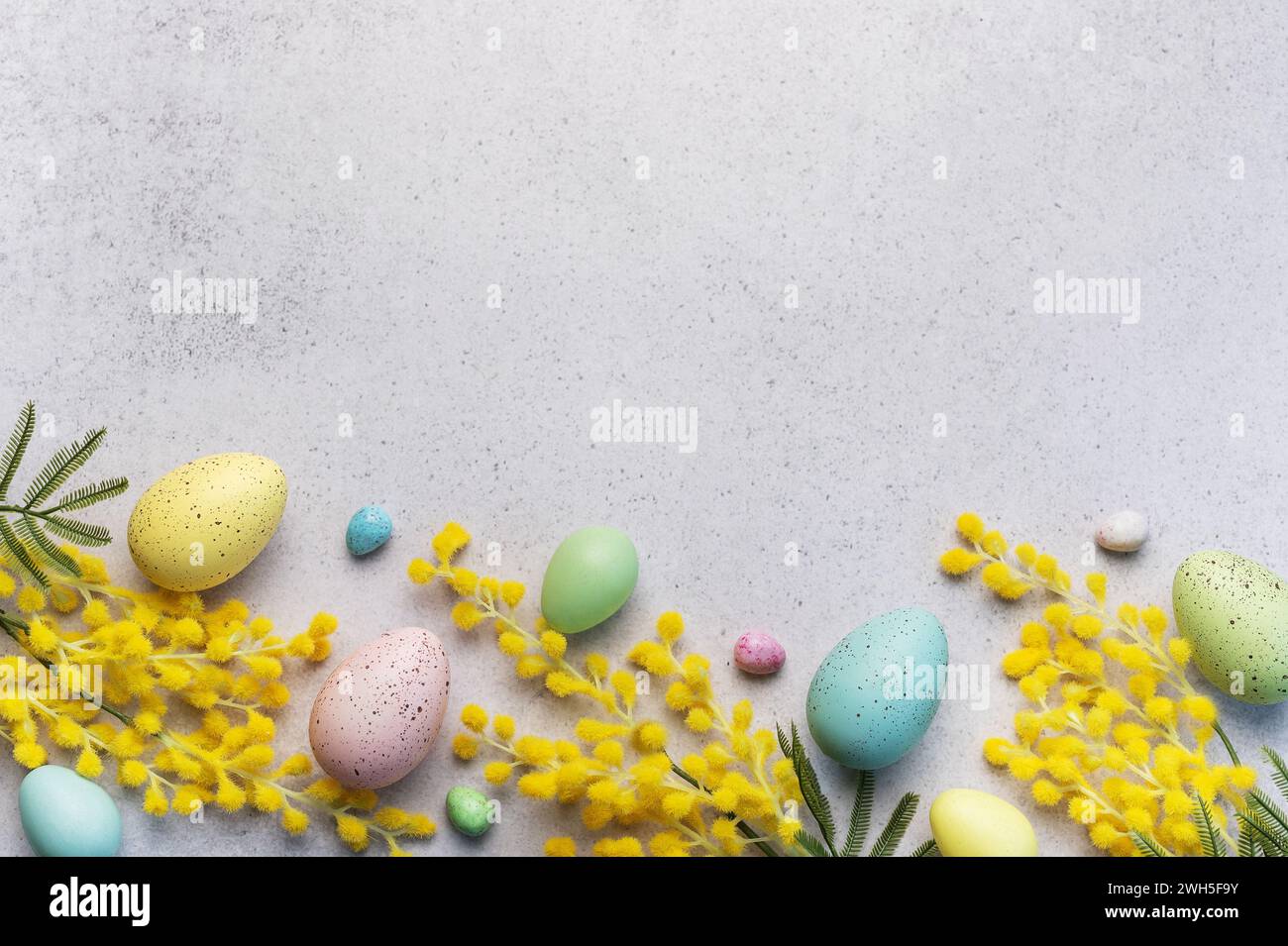 This image features a festive Easter arrangement of pastel-colored eggs ...