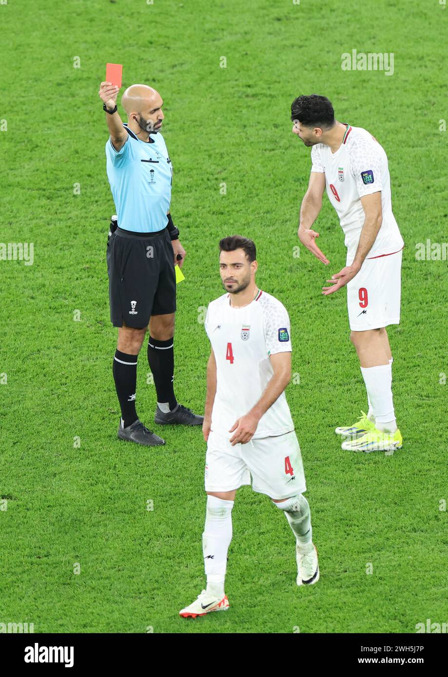 Doha, Qatar. 7th Feb, 2024. Referee Ahmad Alali (L) shows a red card to ...