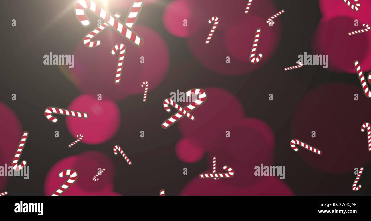 Image of christmas candy canes falling and pink spotlights on black ...