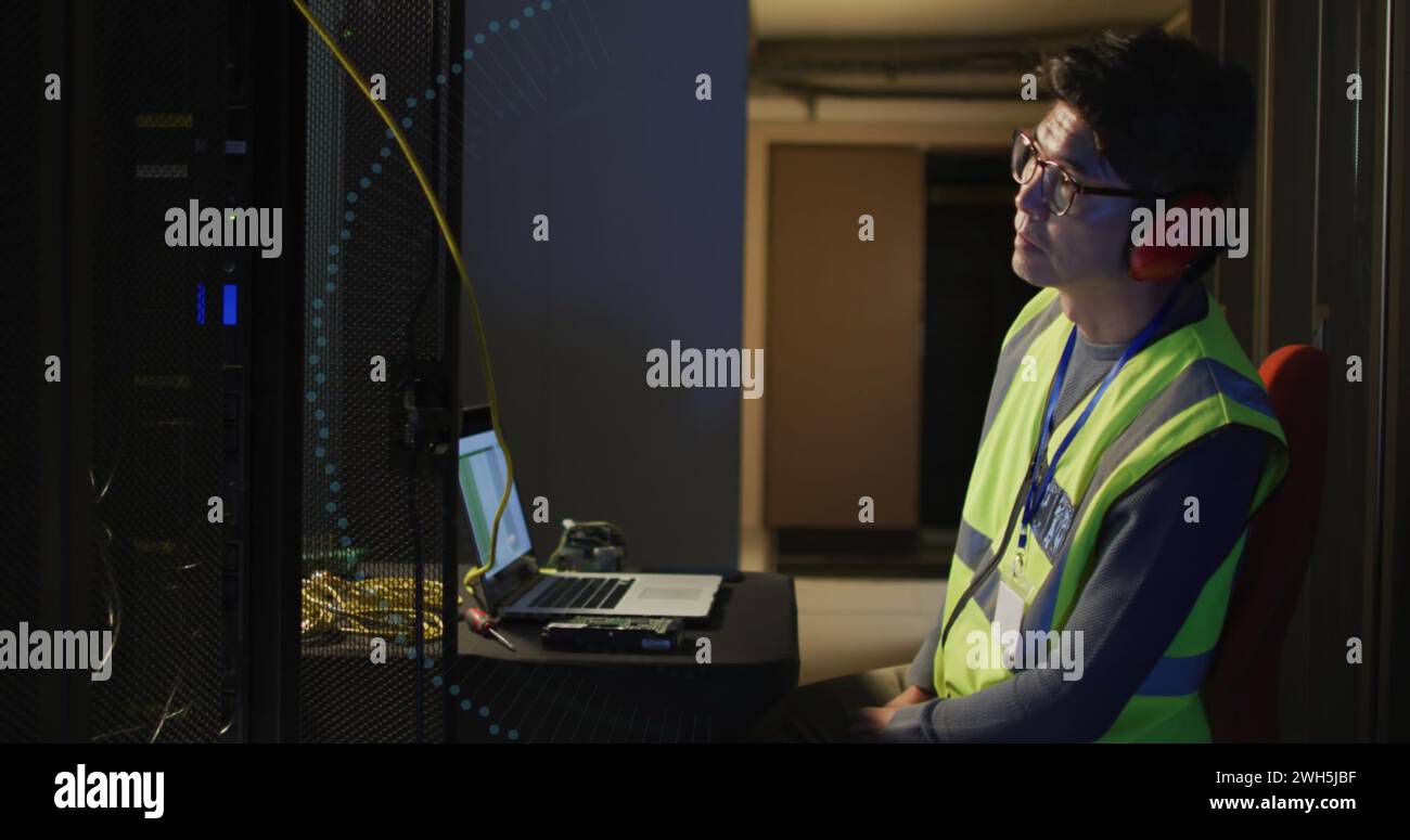 Image of digital padlock over asian man working with laptop in server ...