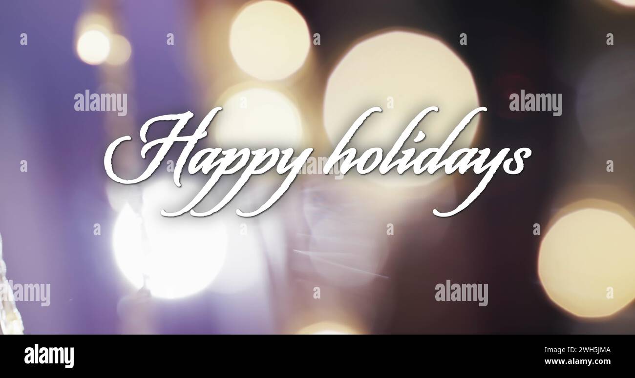 Image of happy holidays text over yellow spots of light background ...