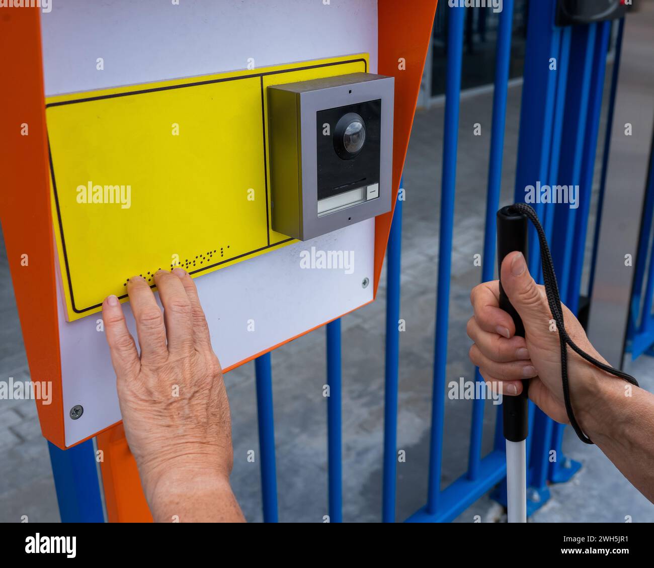 Close-up of the hands of a blind elderly woman reading a text in ...