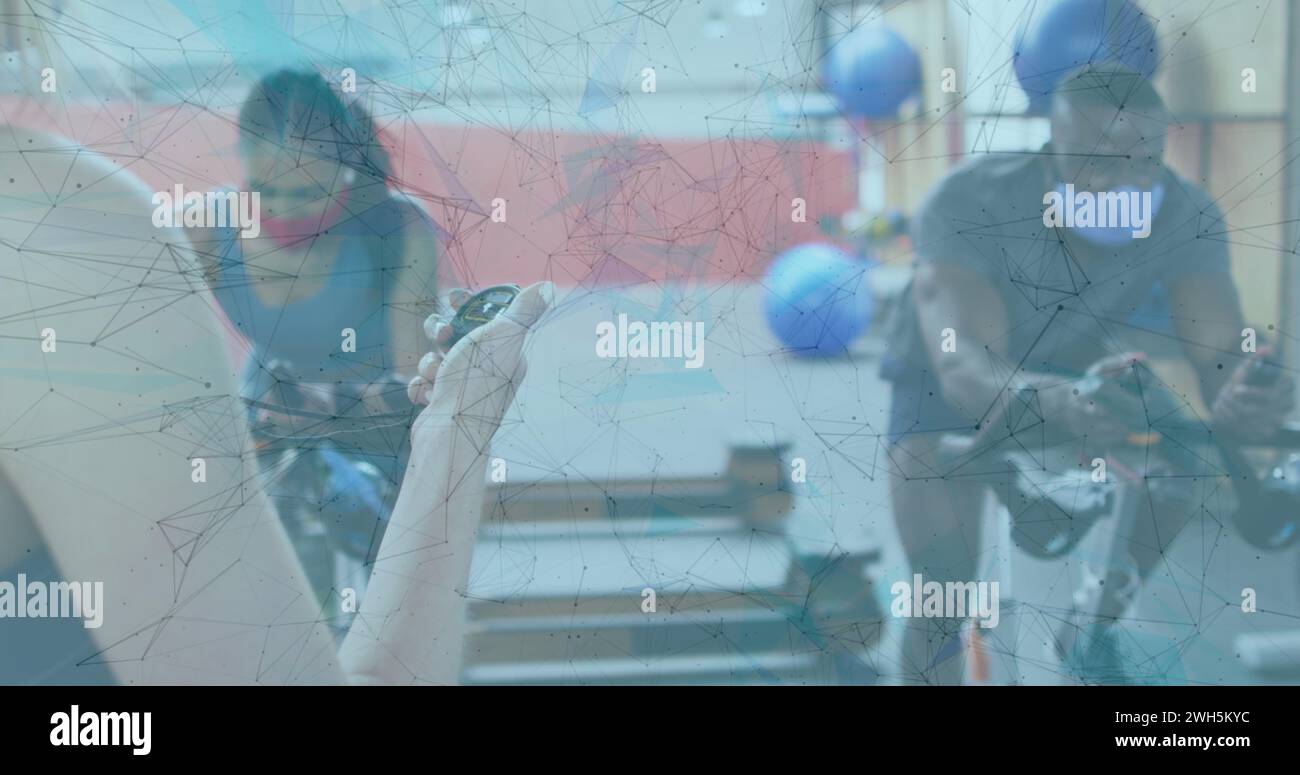 Image of net of connections over diverse group wearing face masks ...