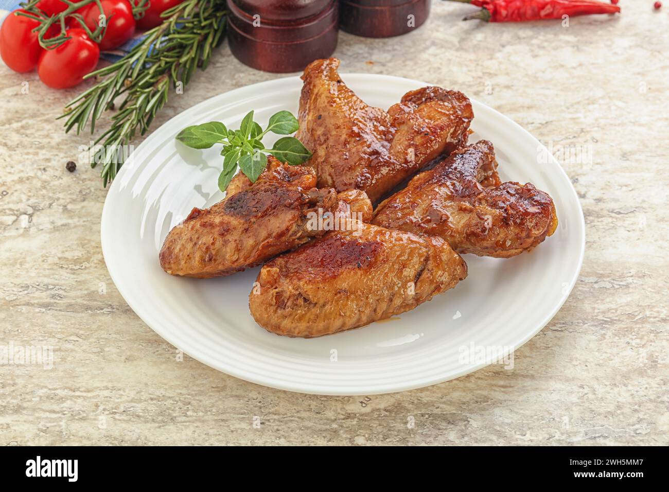 Roasted chicken wings with spicy sauce served basil leaves Stock Photo ...