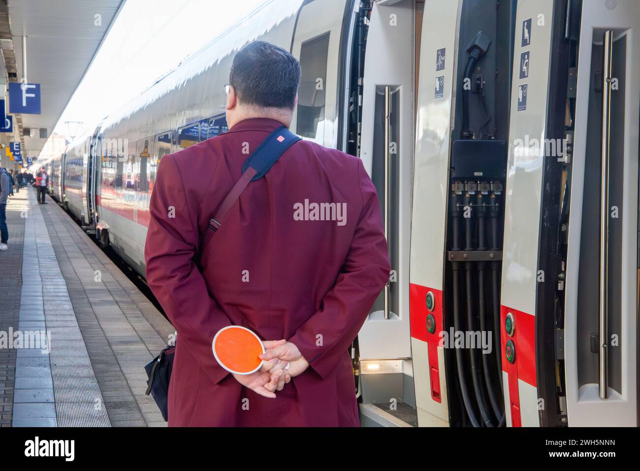 Train attendant at Mannheim (Germany) main station in front of a departing ICE train Stock Photo ...