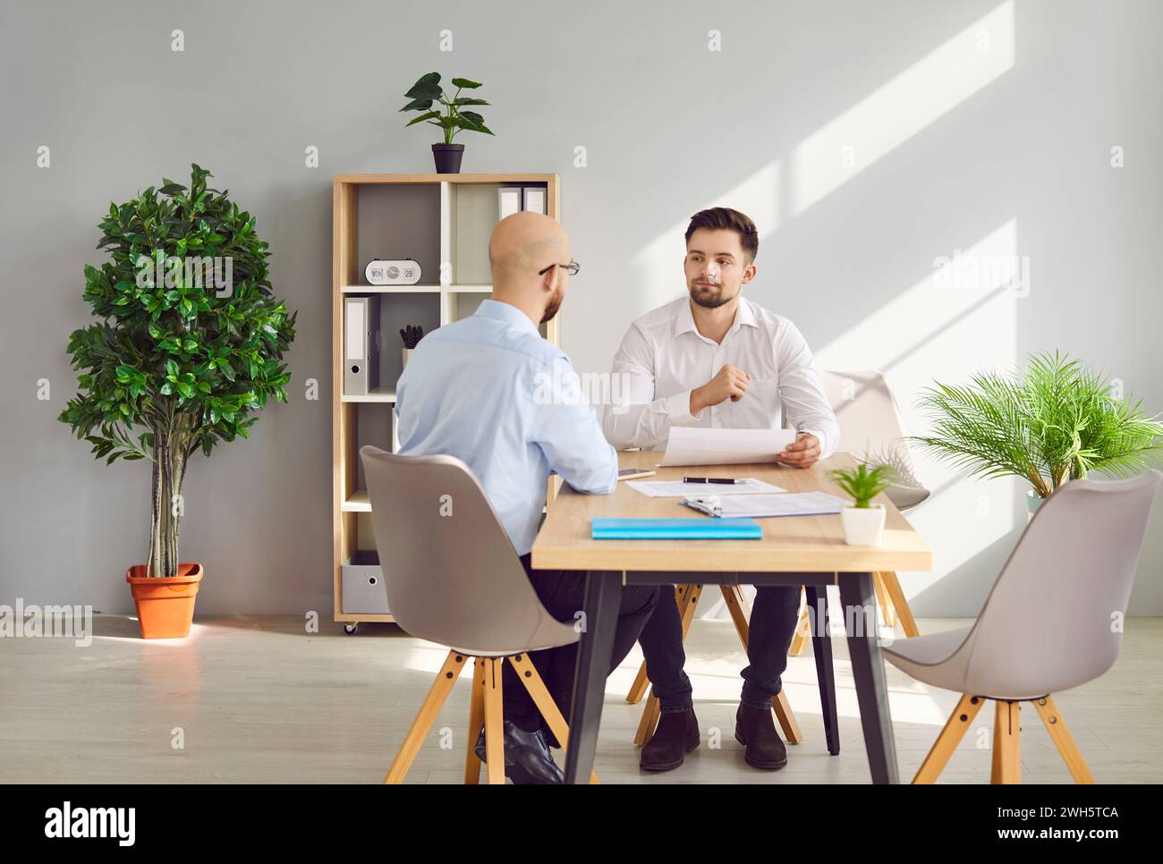 Two business people talking during meeting in office Stock Photo - Alamy