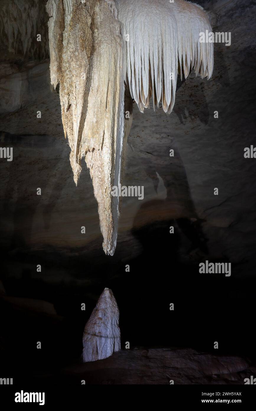 Majestic Stalactite and Stalagmite Formation in a Dark Cave Stock Photo ...