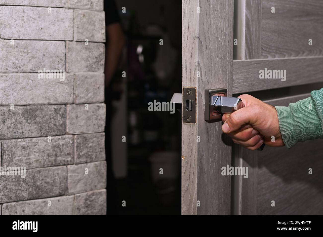 Hand closing entrance door hi-res stock photography and images - Alamy
