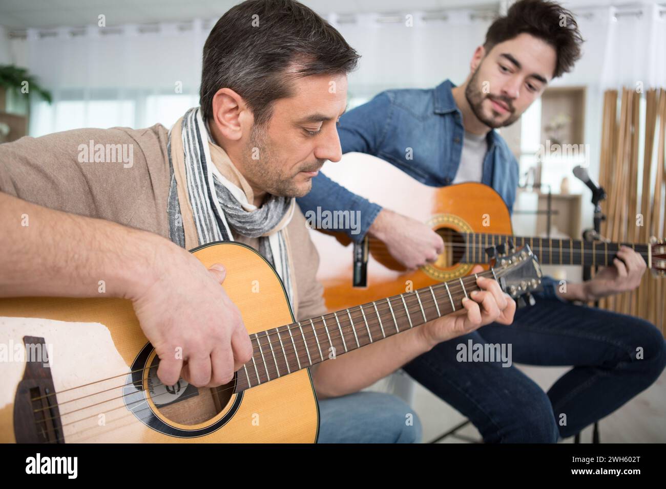 two guitar players with classic guitars Stock Photo - Alamy
