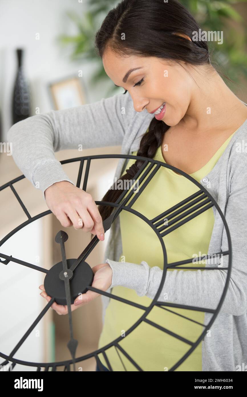 Woman setting clock hi-res stock photography and images - Alamy