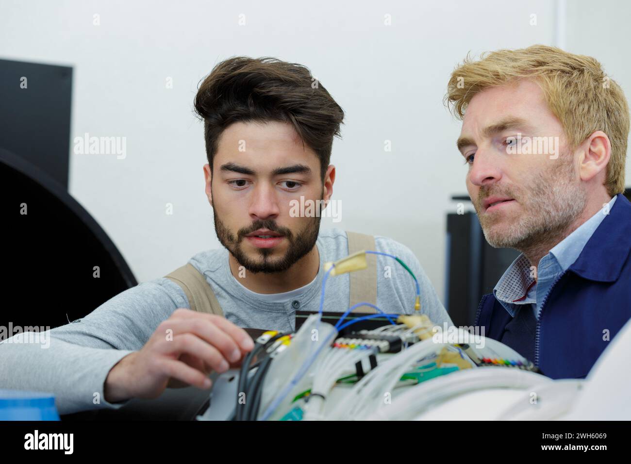 two technicians working on a machine Stock Photo - Alamy