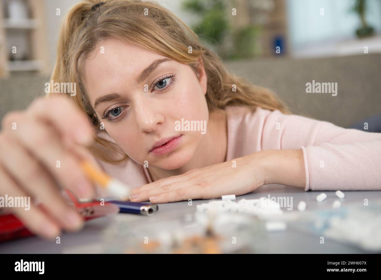 woman putting finished cigarette in an ashtray Stock Photo - Alamy