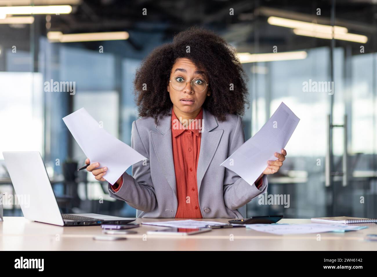 Young female professional in an office setting appears surprised ...