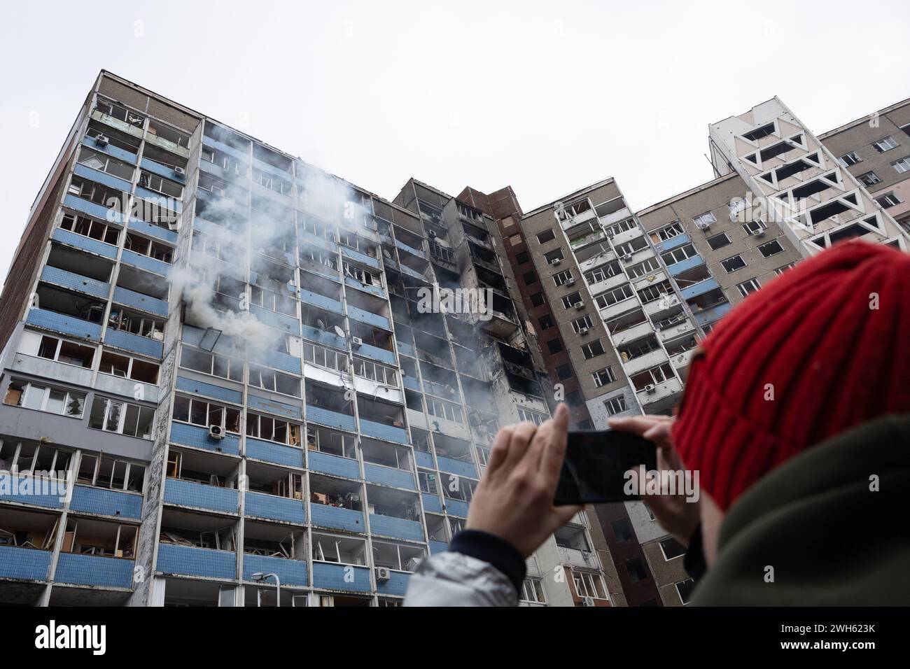 Kyiv, Ukraine. 07th Feb, 2024. A man takes photos of a building damaged ...