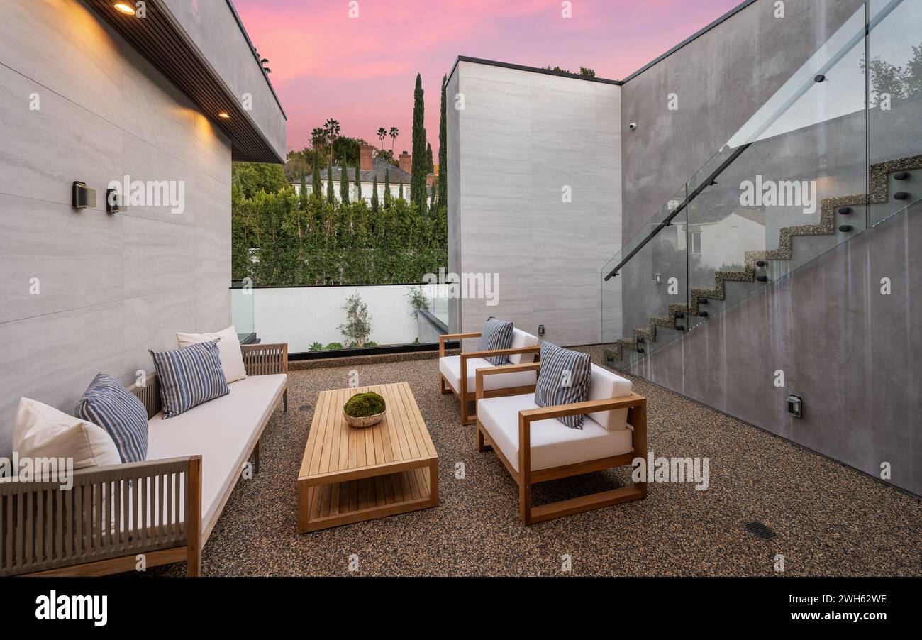 A cozy outdoor lounge area beside a staircase Stock Photo - Alamy