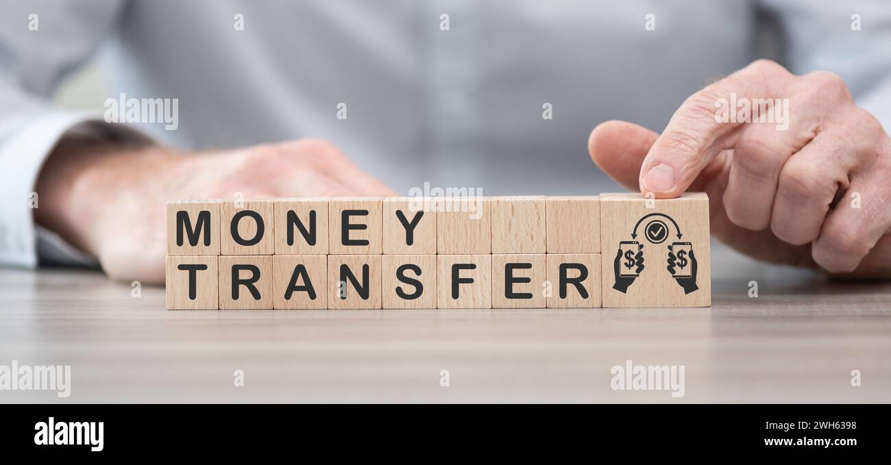 Wooden blocks with symbol of money transfer concept Stock Photo - Alamy