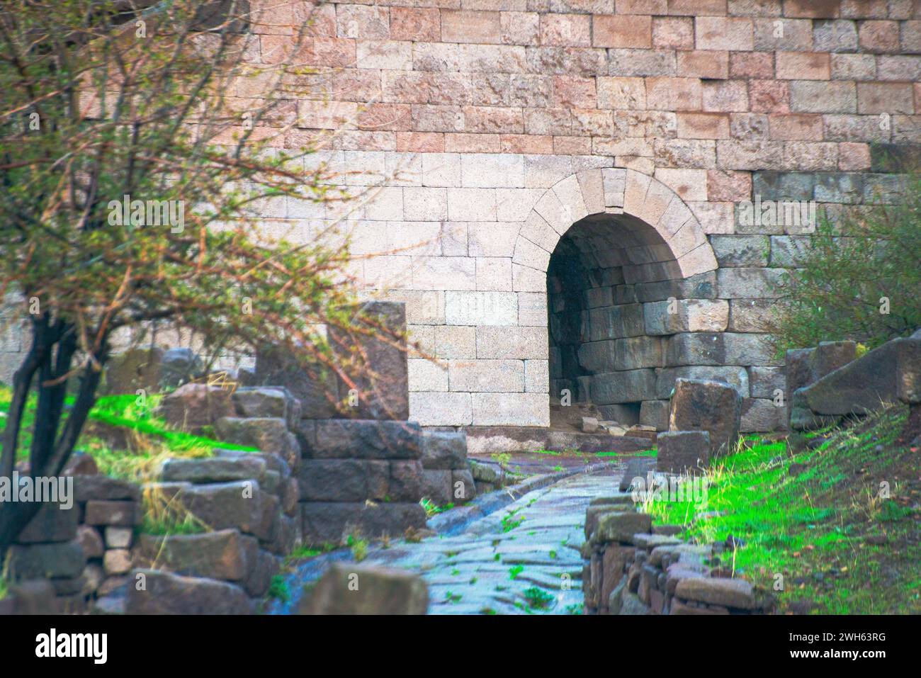 A grand entrance to an ancient amphitheater, featuring a monumental ...