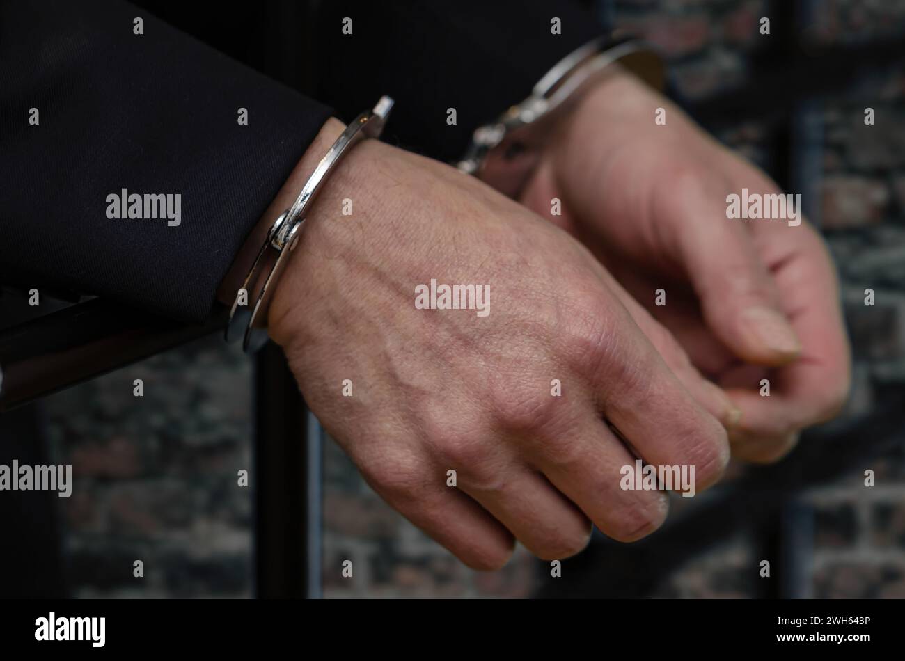 Handcuffs on hands hi-res stock photography and images - Alamy