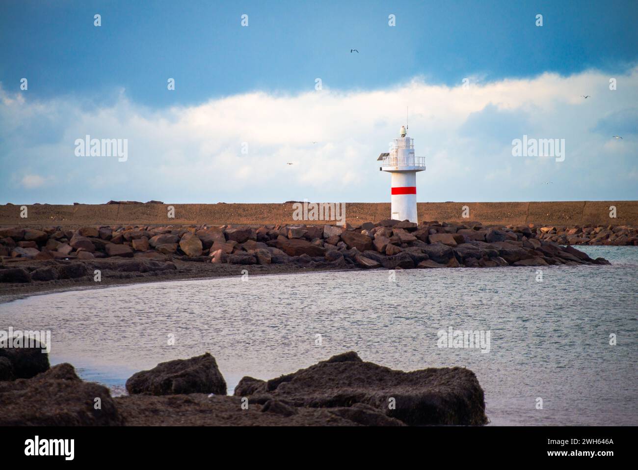 A captivating coastal scene featuring a lighthouse standing proudly by ...