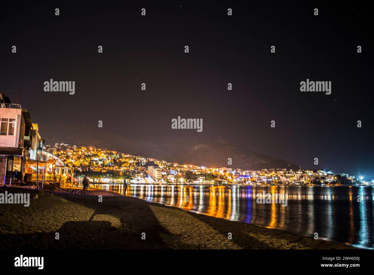 A mesmerizing night photo capturing the coastal town's vibrant lights ...