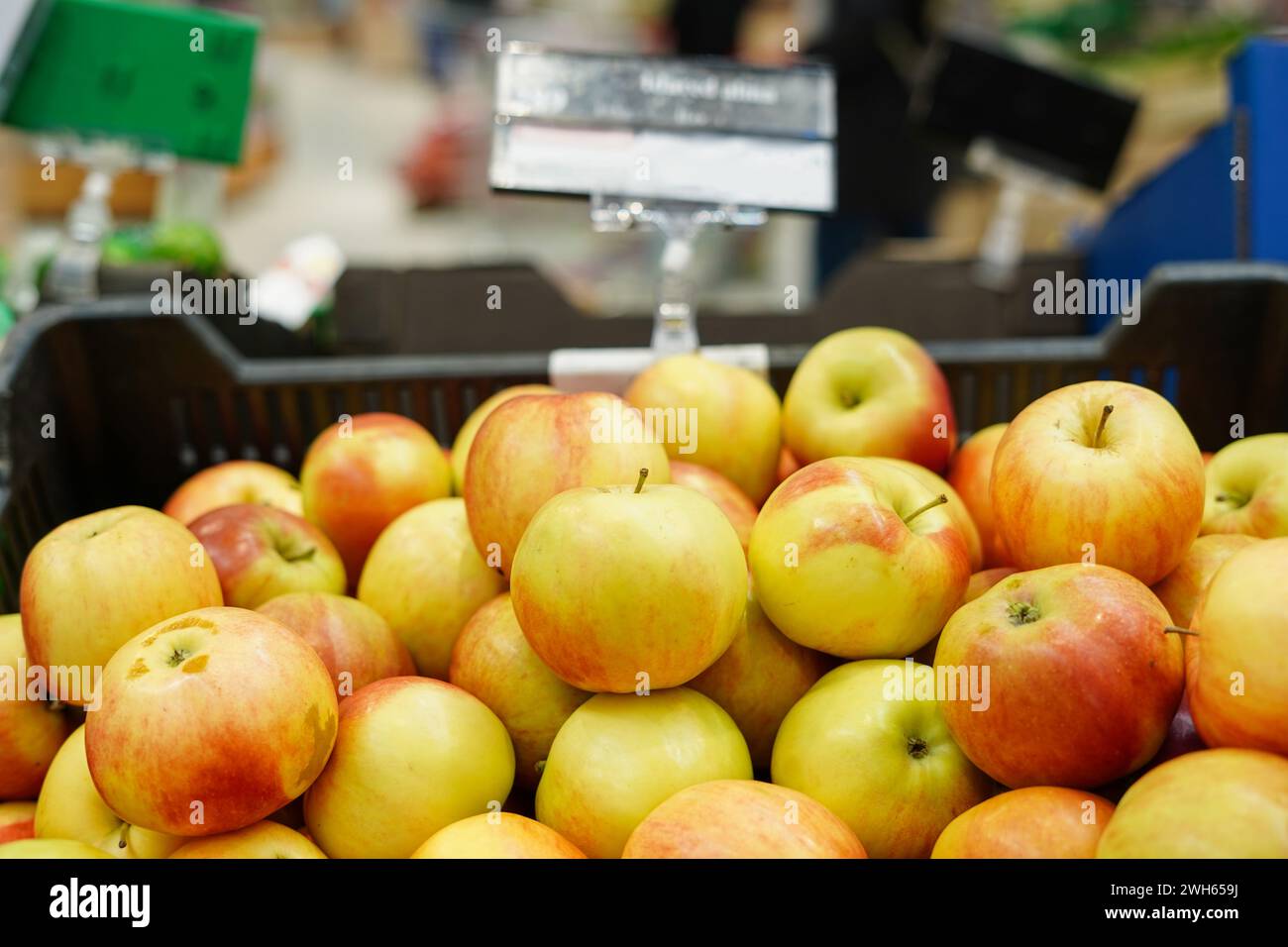 Red and yellow apples in the boxes in big grocery store. ripe apples ...