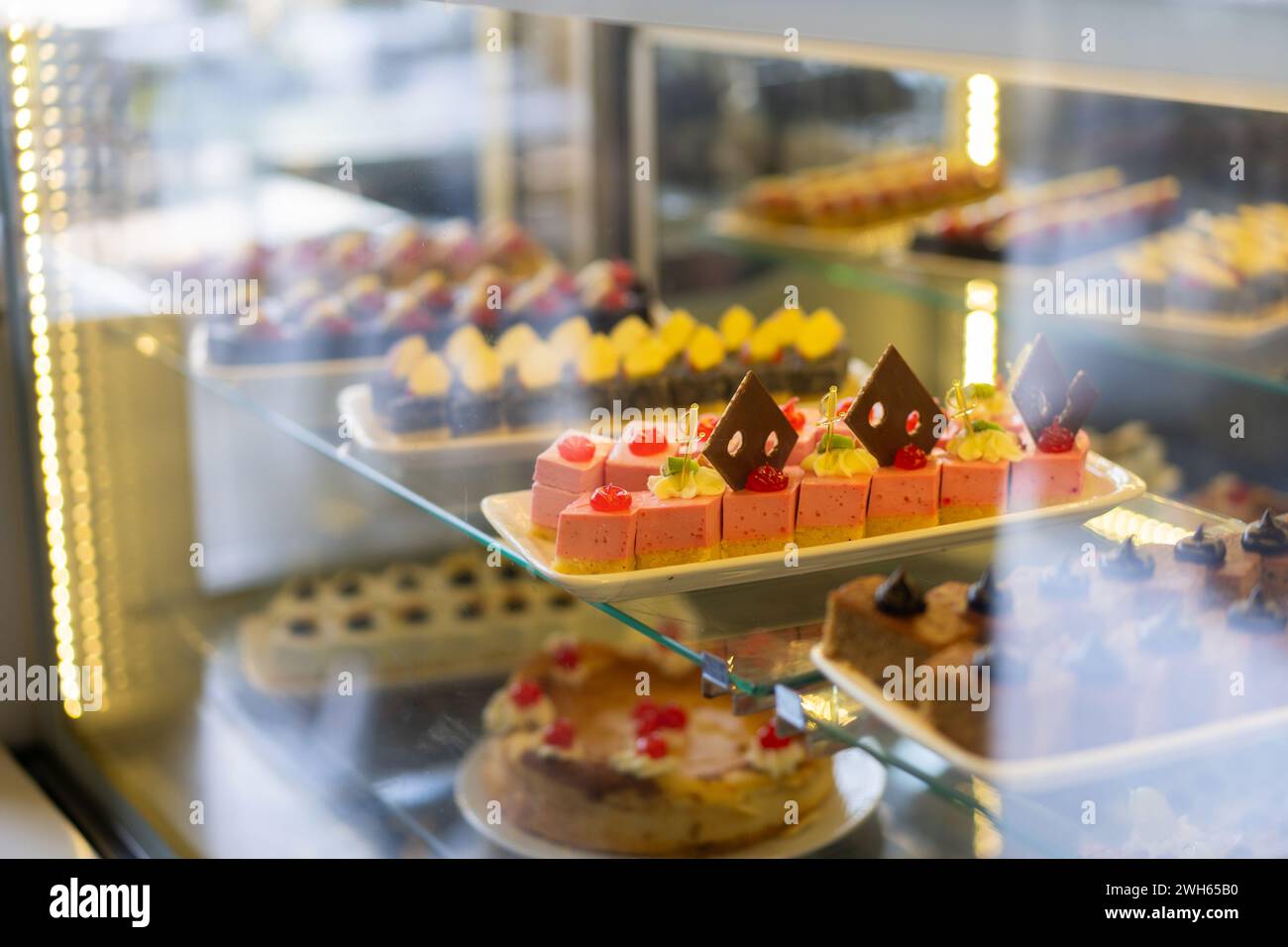 Showcase with sweets. Various desserts and cakes for sale Stock Photo ...