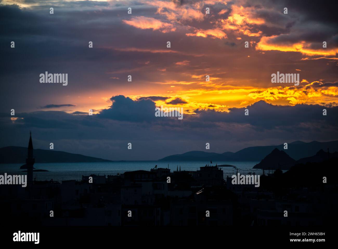 A beautiful sunset in the coastal town of Bodrum, Turkiye, paints the ...