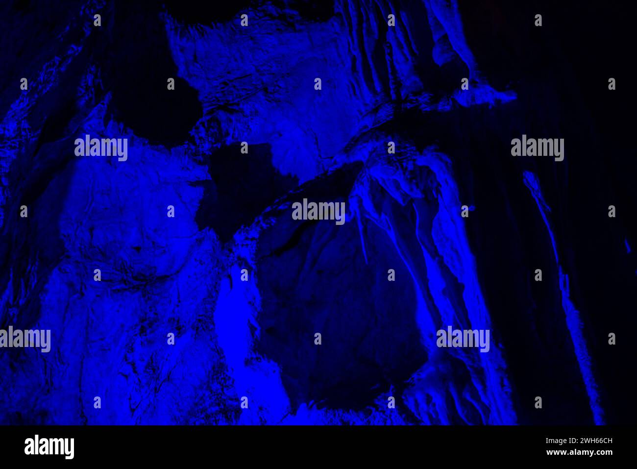 Journey through a vibrant cave adorned with colorful walls, stalactites ...