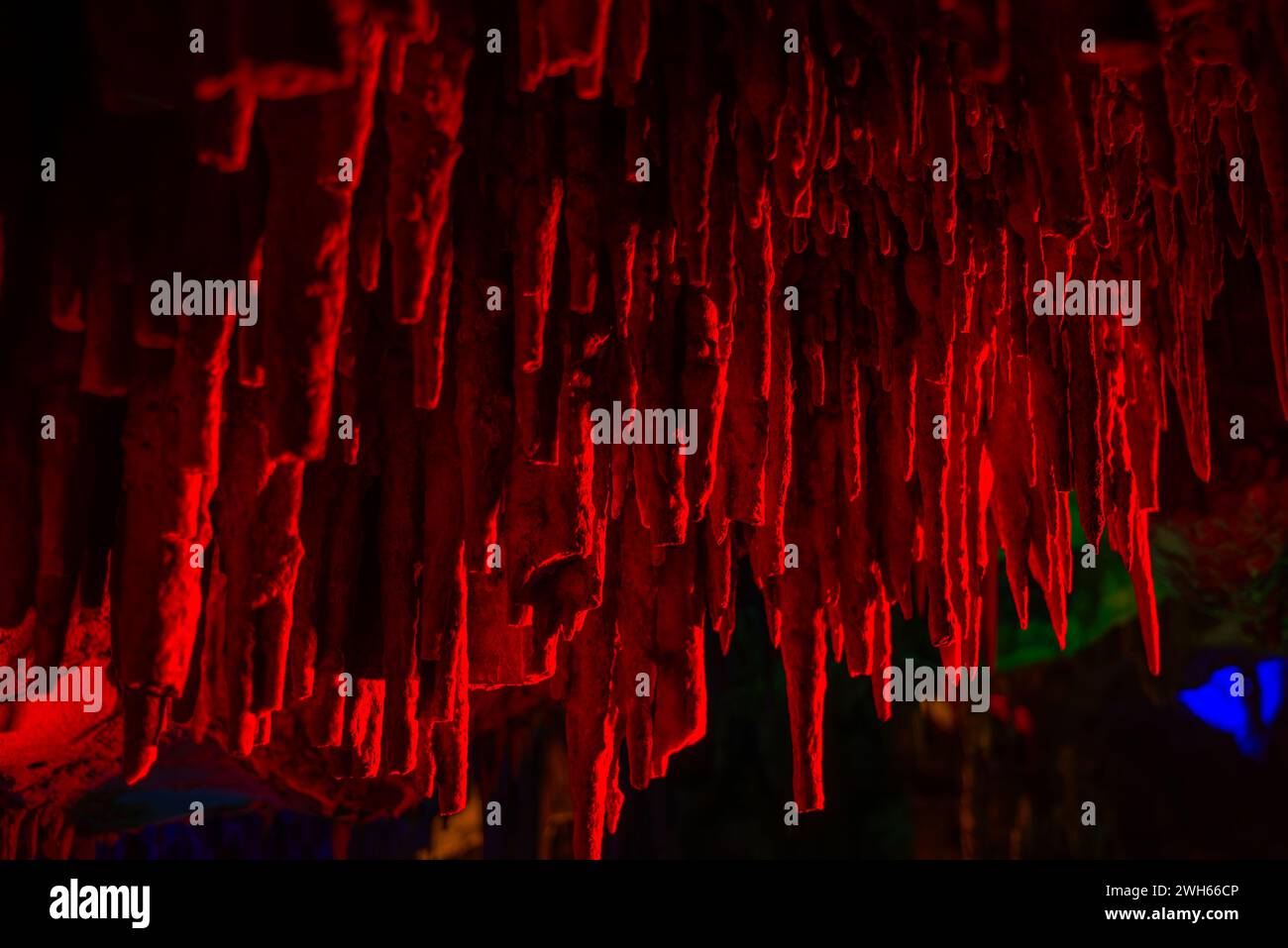 Journey through a vibrant cave adorned with colorful walls, stalactites ...