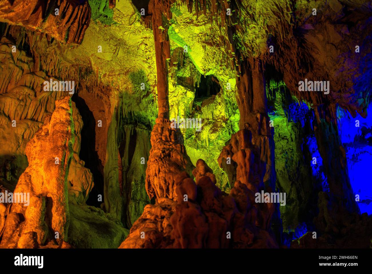 Journey through a vibrant cave adorned with colorful walls, stalactites ...
