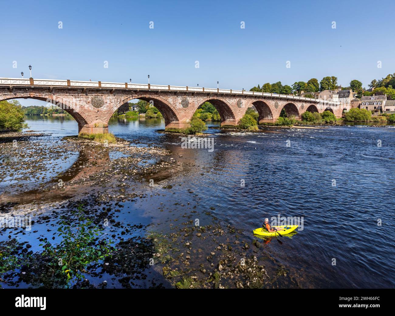 A kayaker beside the Old Bridge over the River Tay in the City of Perth ...