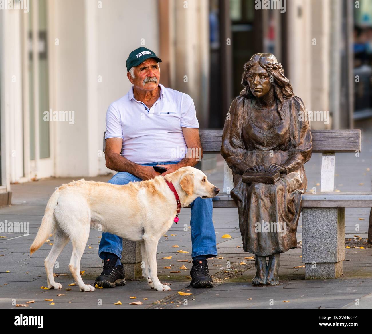 A man and his dog sit beside the Fair maid statue in the City of Perth ...