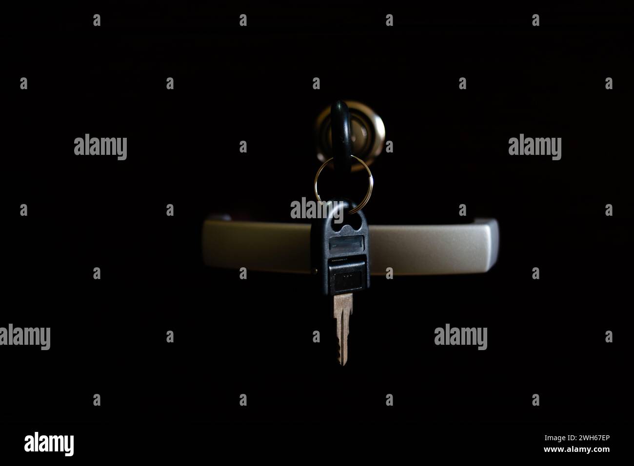 A key securely sits in its socket on the desk, ensuring access and ...