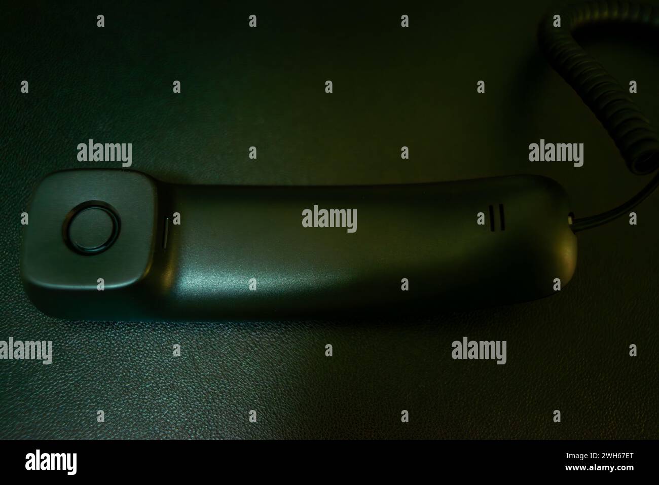 A sleek black phone handset, a modern communication device, offers ...