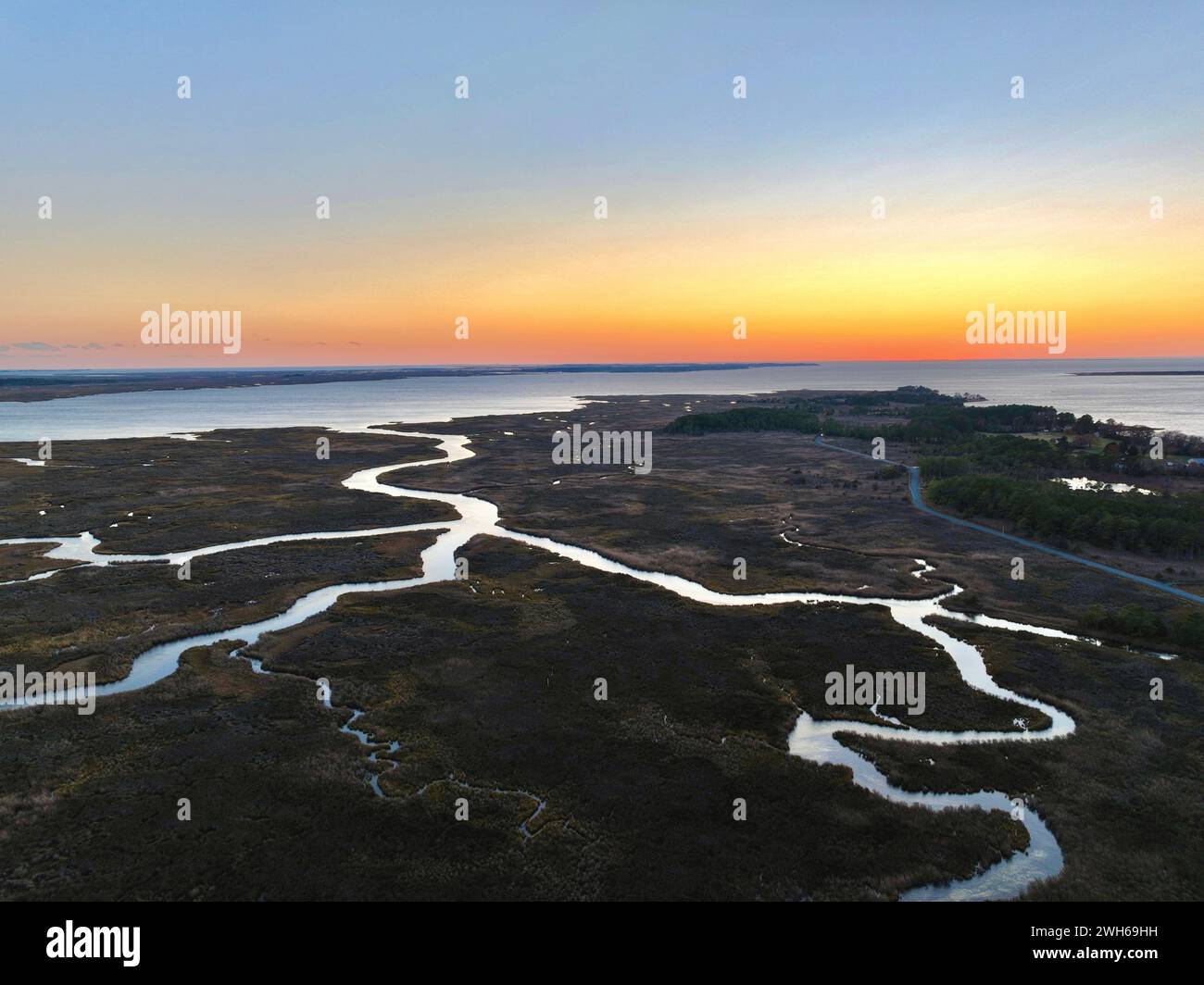An aerial view of Mount Vernon, Maryland at golden sunset, casting a ...