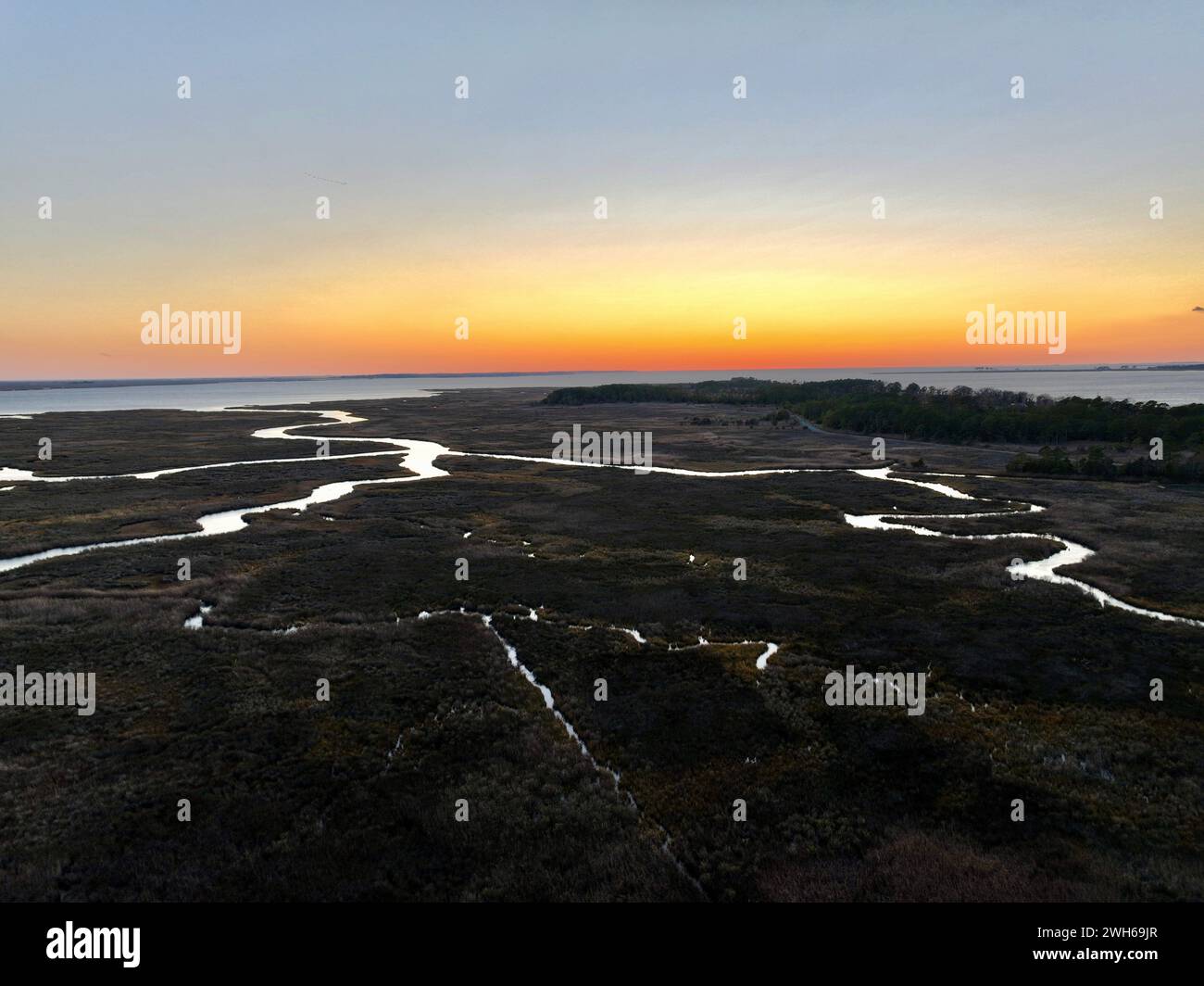 An aerial view of Mount Vernon, Maryland at golden sunset, casting a ...