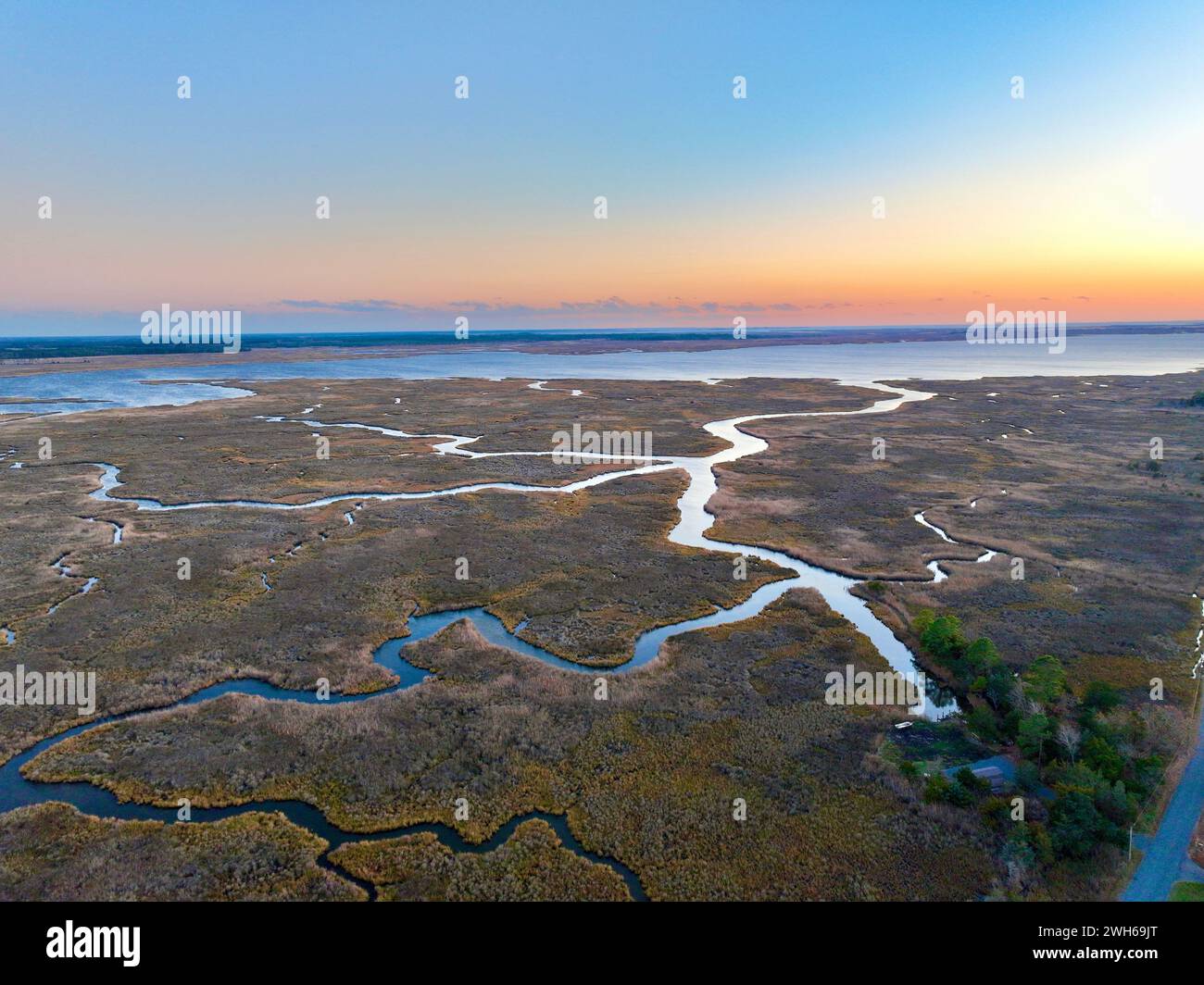 An aerial view of Mount Vernon, Maryland at golden sunset, casting a ...